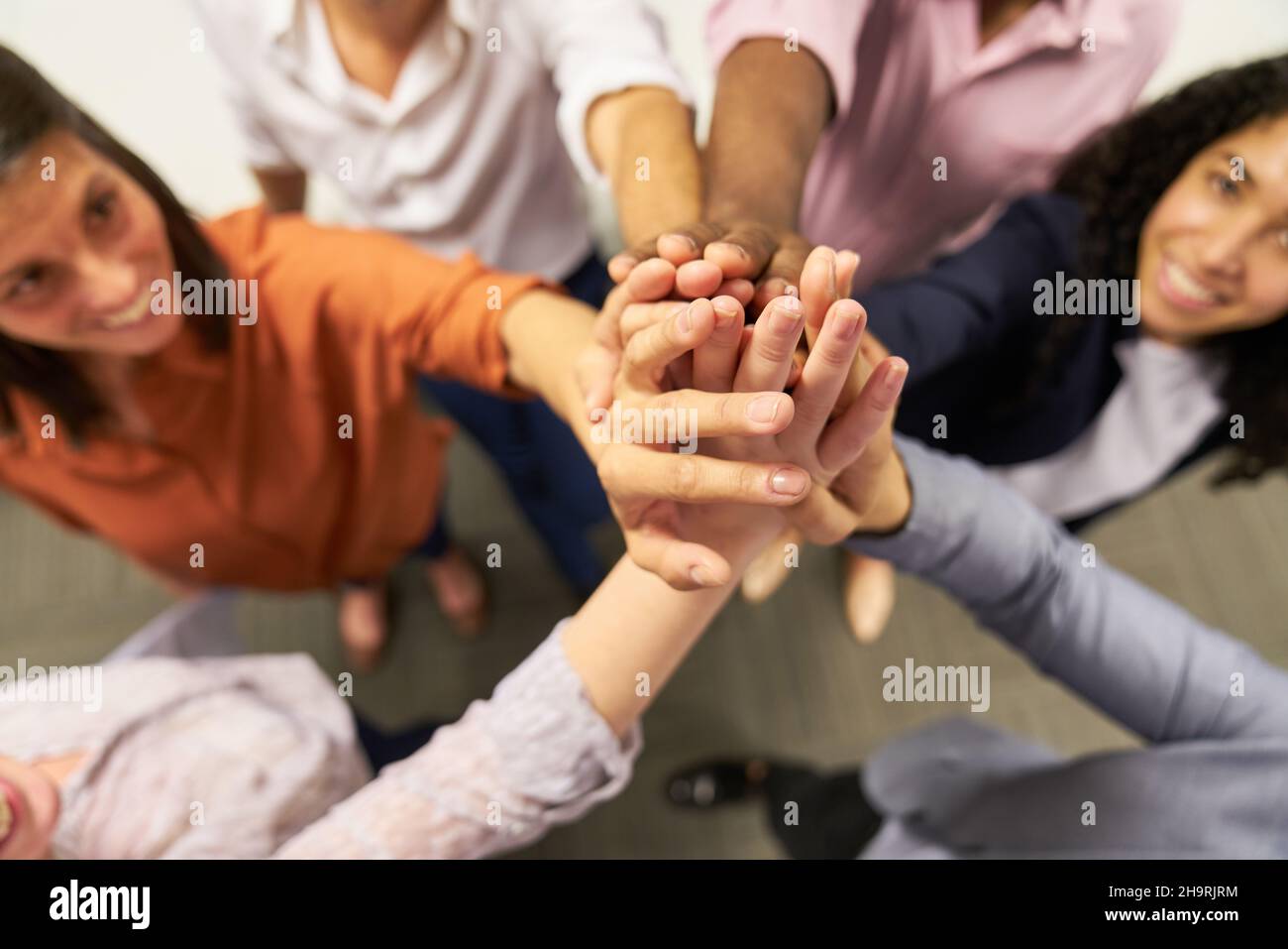 Business people give each other a high five as a symbol of team ...