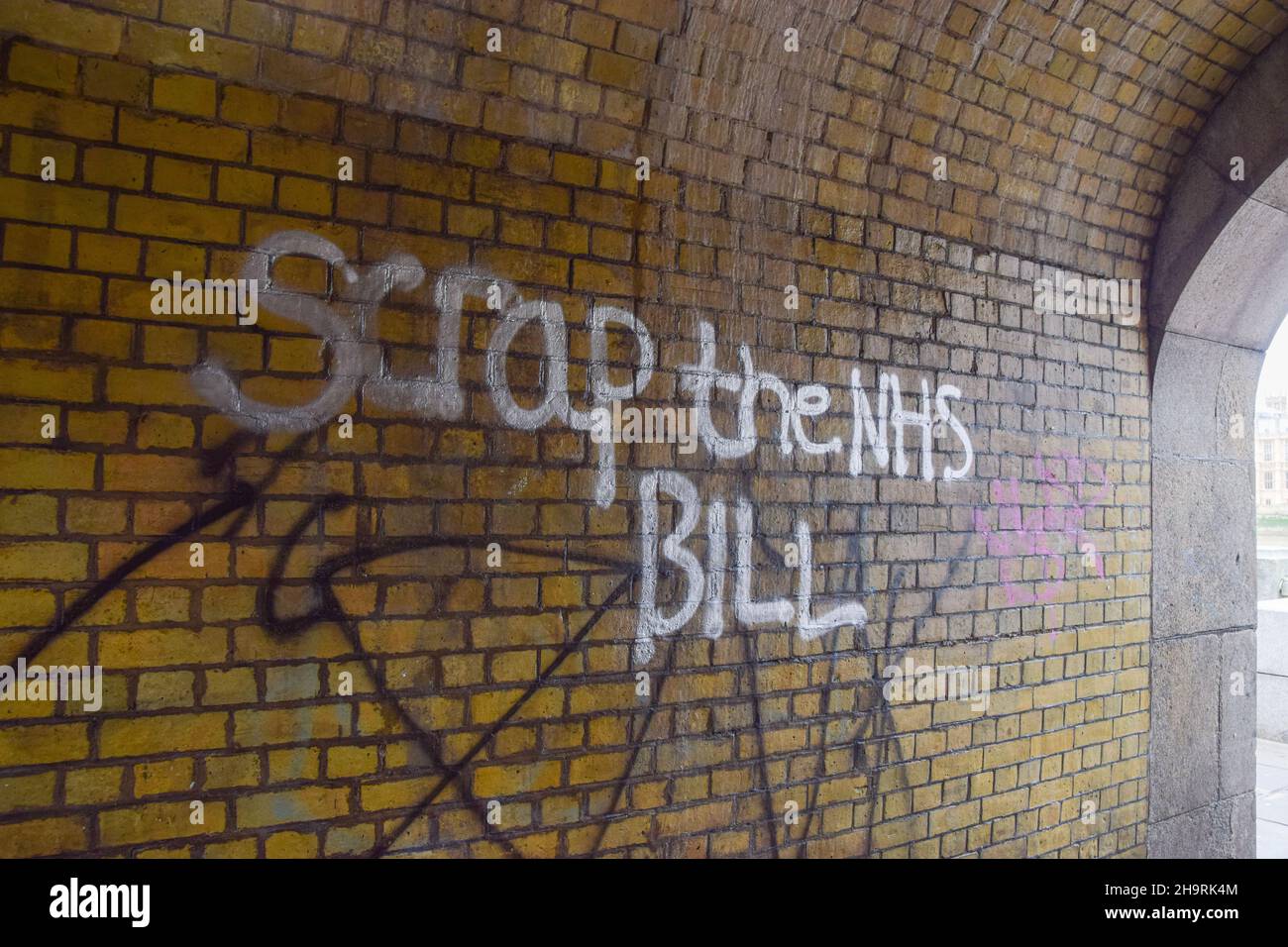 'Scrap The NHS Bill' graffiti under Westminster Bridge opposite the ...