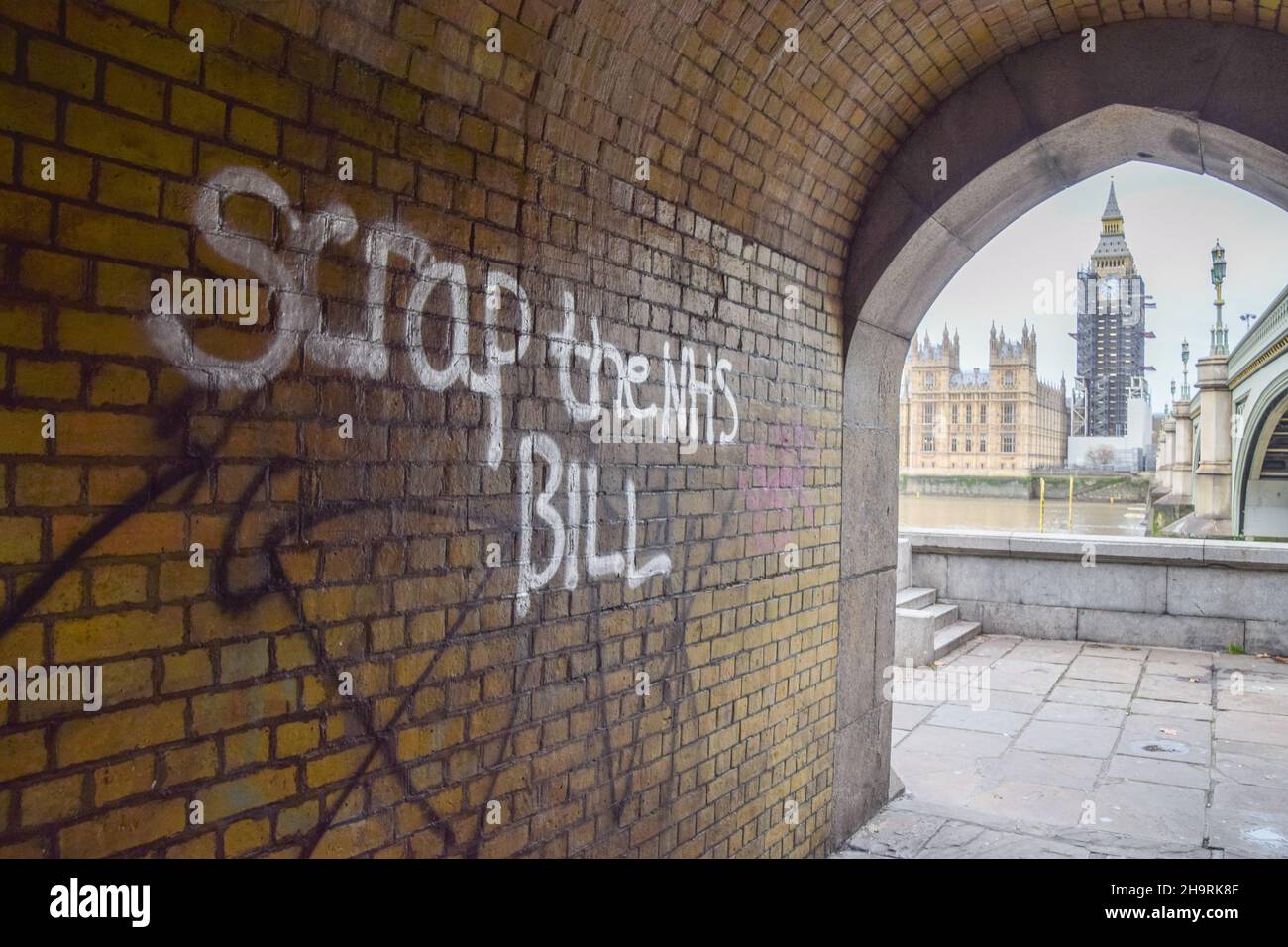 'Scrap The NHS Bill' graffiti under Westminster Bridge opposite the ...
