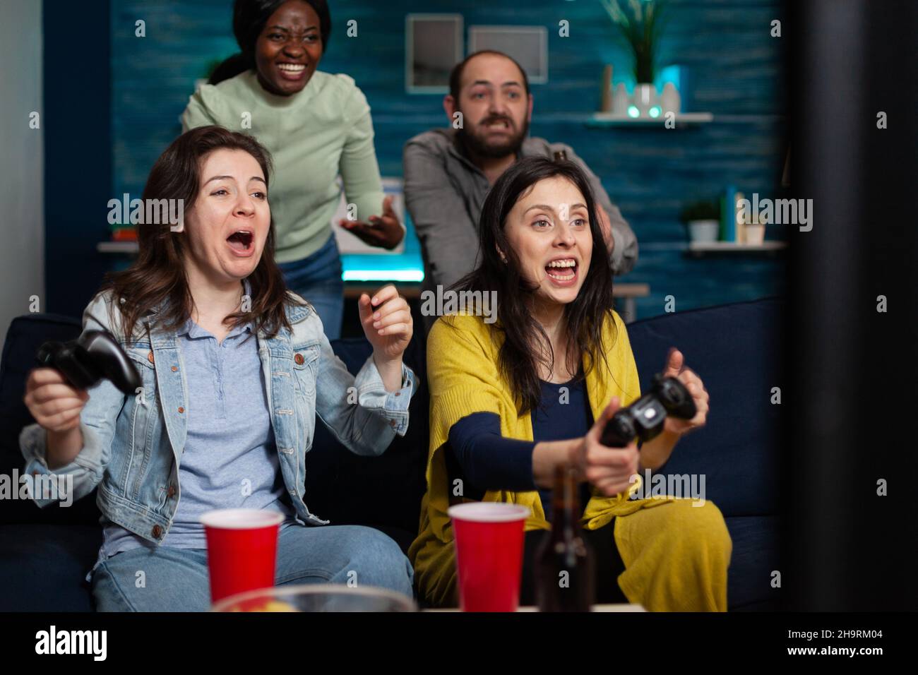 Happy smiling women playing videogames using gaming joystick winning ...