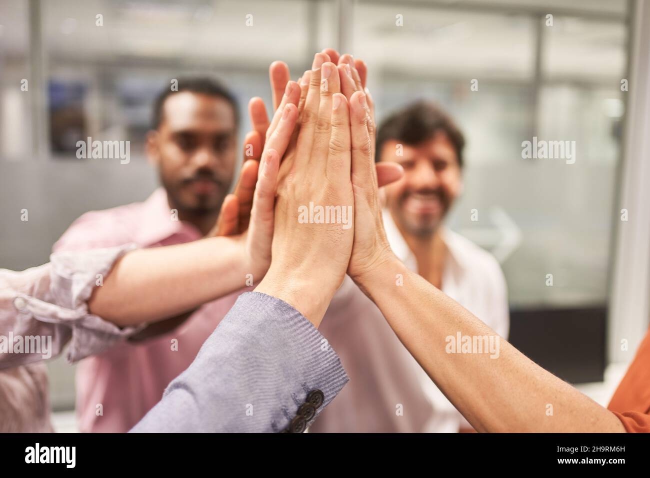 Business people giving the high five as a symbol for team building and ...