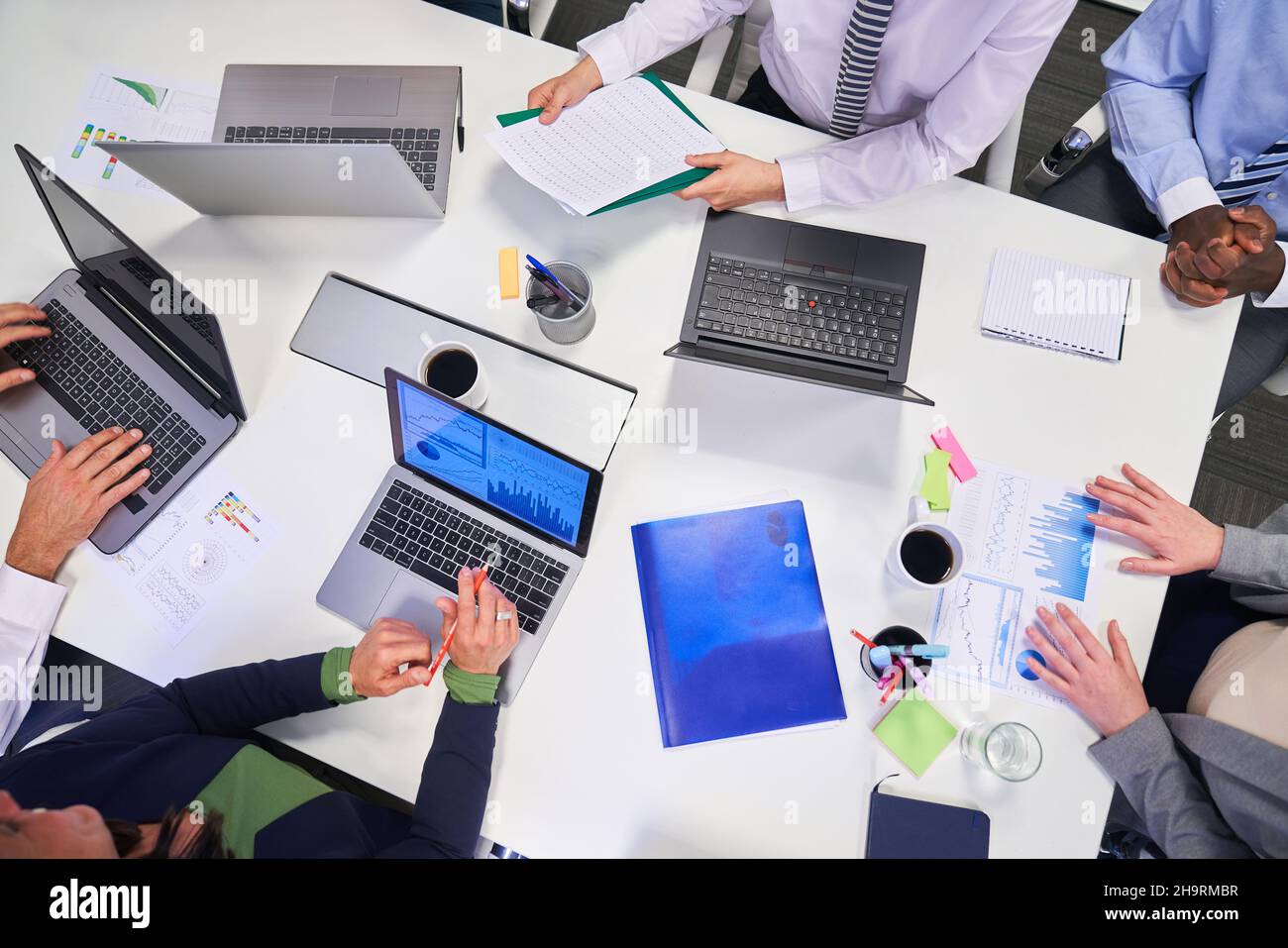 Business people in meeting working together at conference table with ...