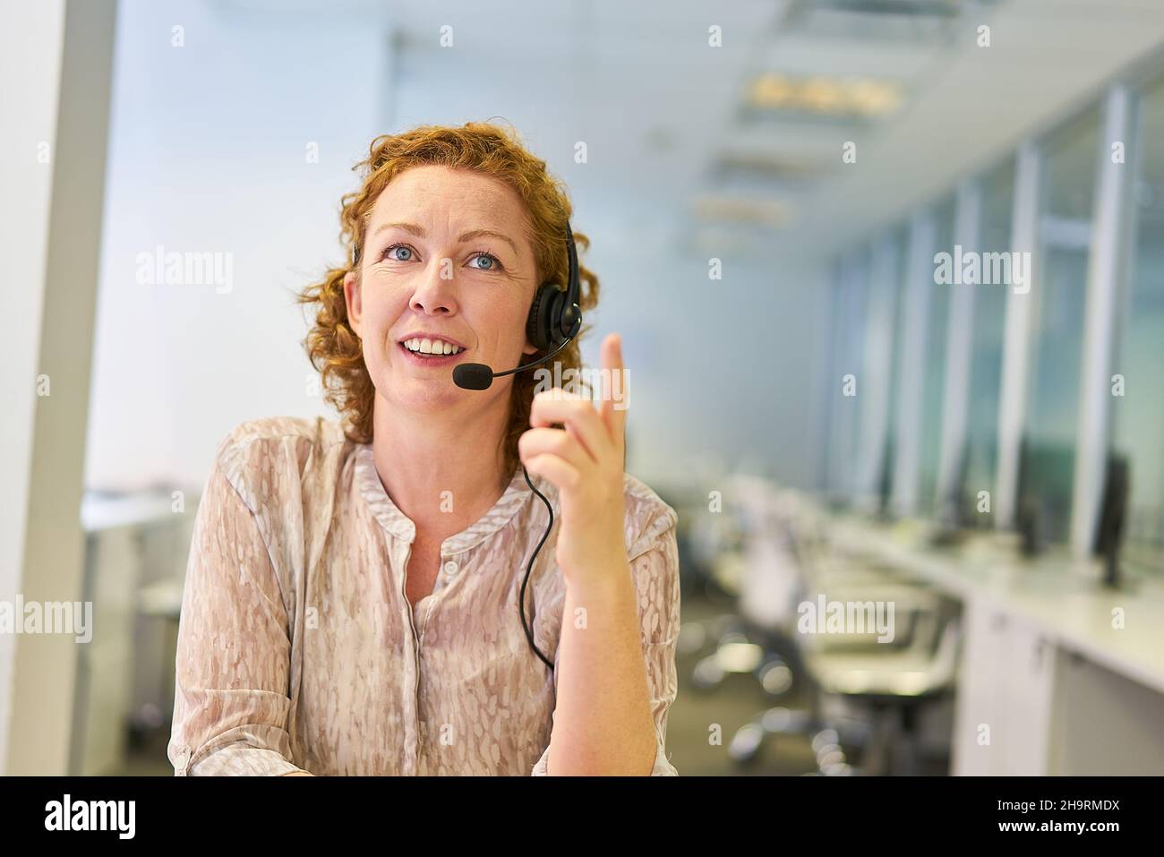 Young businesswoman in the call center during customer advice or in the ...