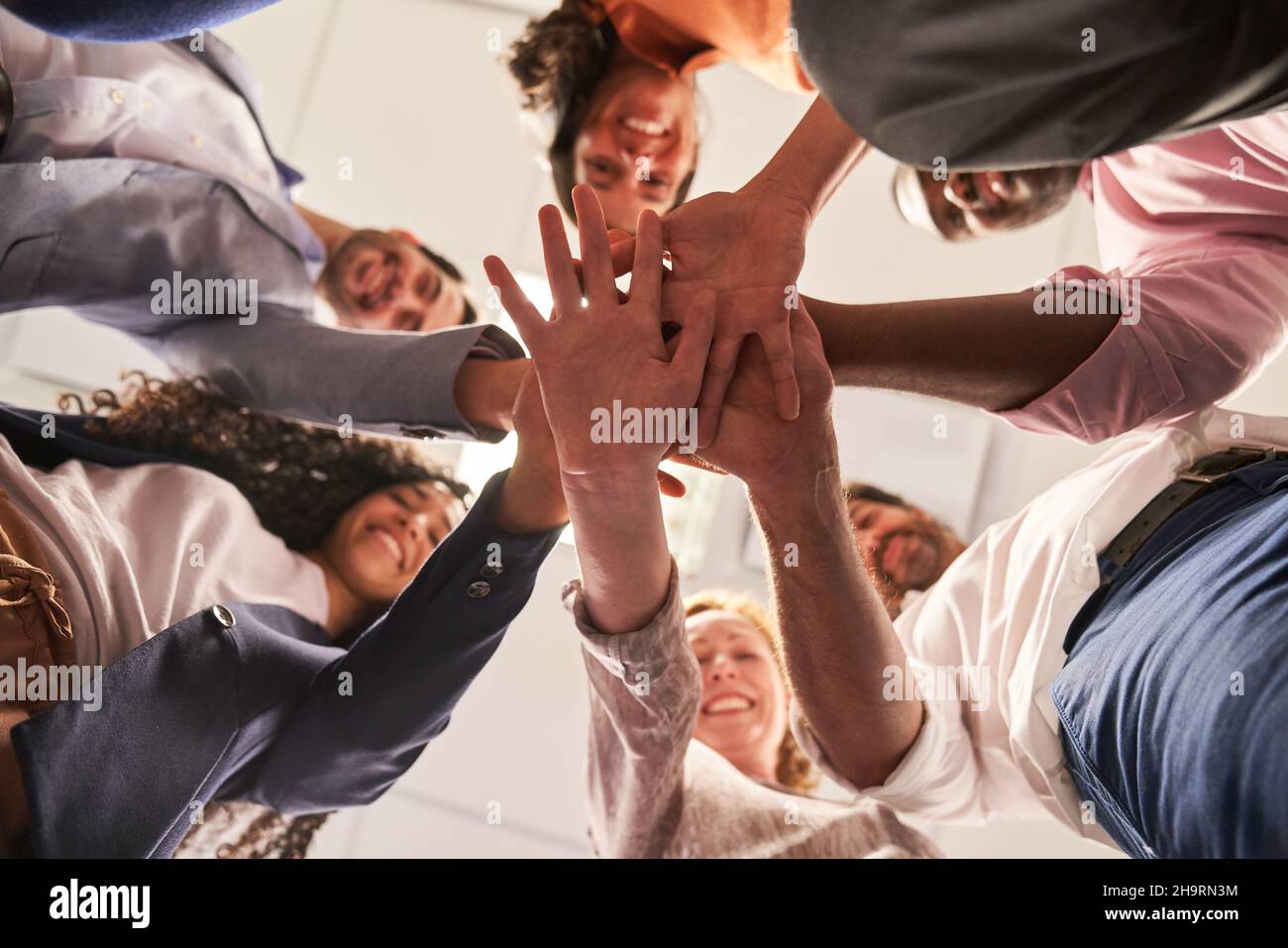 Group of friends as a startup team stacking hands for team spirit and ...