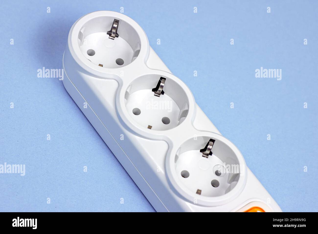 Triple socket white European power adapter with different wires at home ...