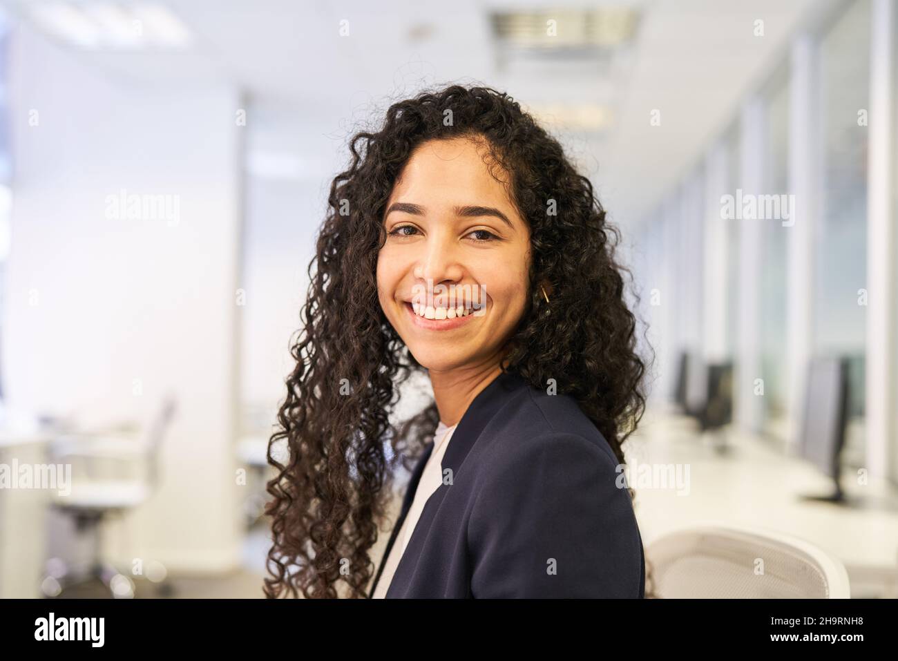 Young business woman as a successful start-up founder in an open-plan ...