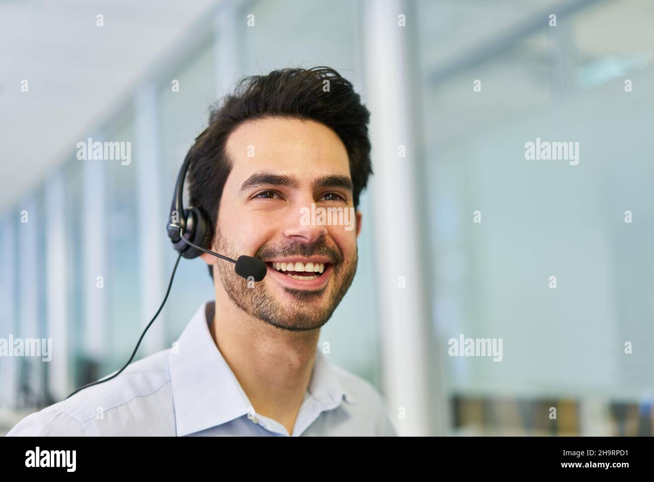 Businessman with headset talking to a customer as a customer service ...