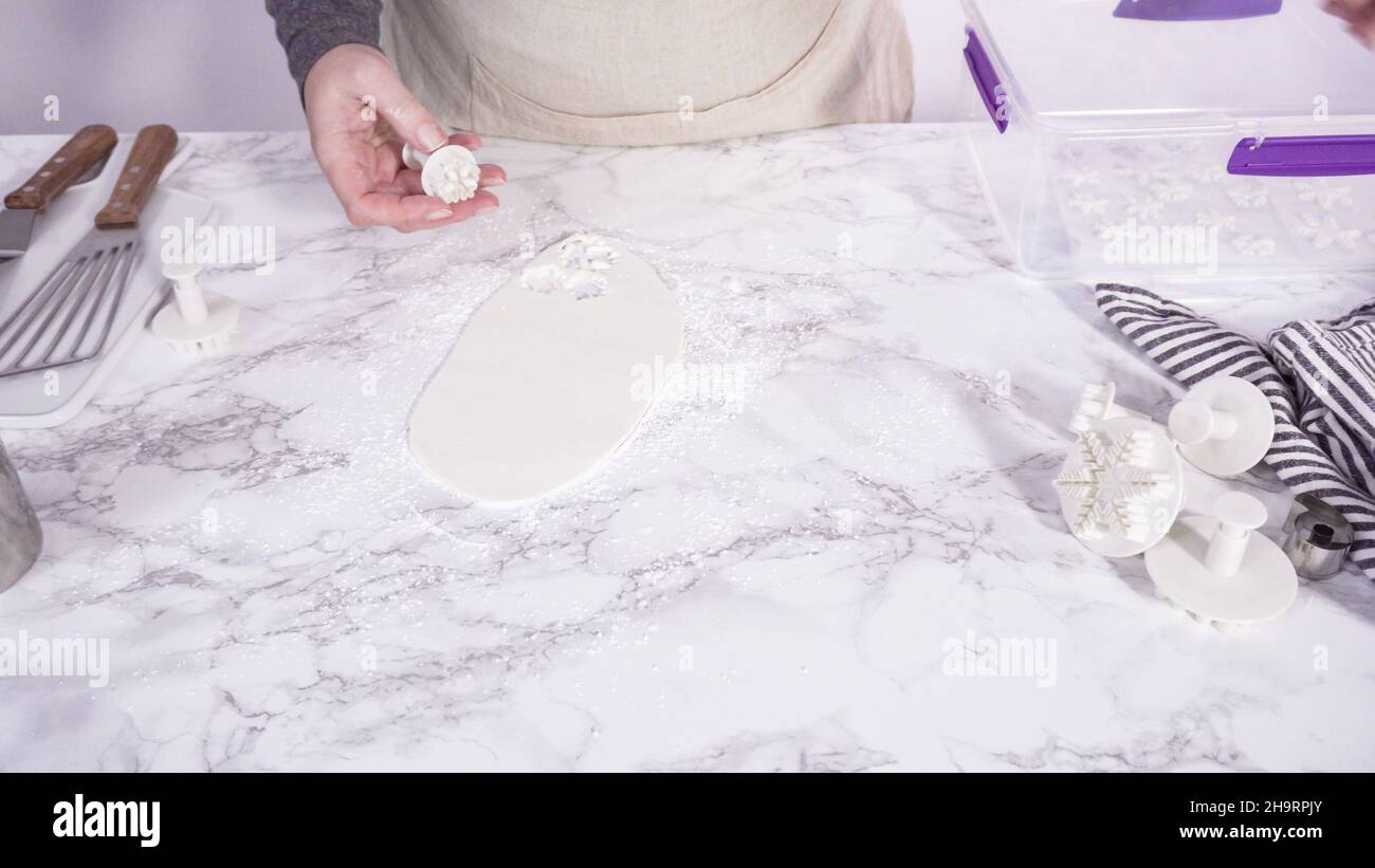 Step by step. Cutting out snowflakes with cookie cutters out of white ...