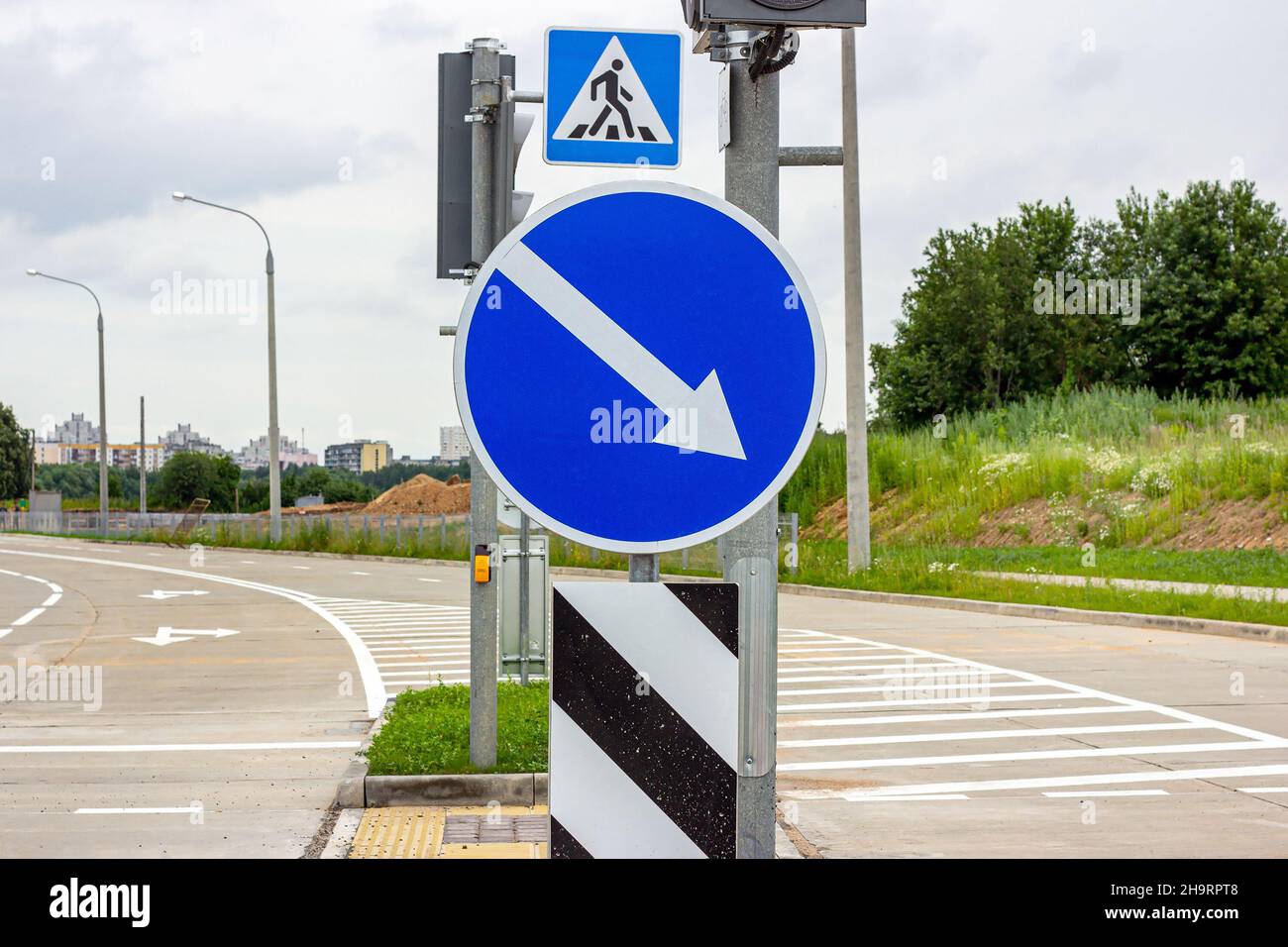 Blue and white warning round turn direction indication road sign with ...