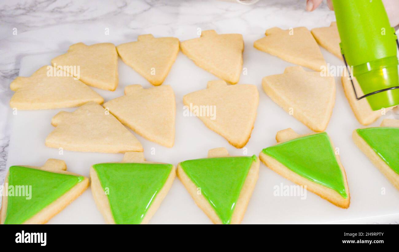 Stp by step. Icing Christmas tree-shaped sugar cookies with green royal ...