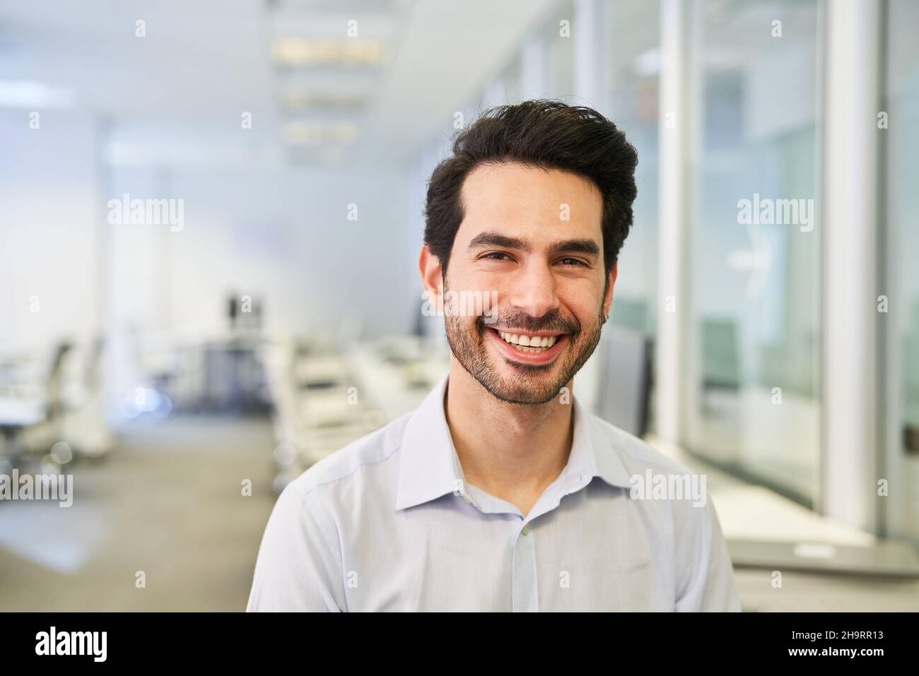 Happy young businessman as a successful start-up founder in an open ...