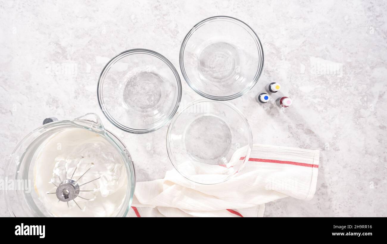 Flat lay. Step by step. Mixing in food coloring into the meringue to ...