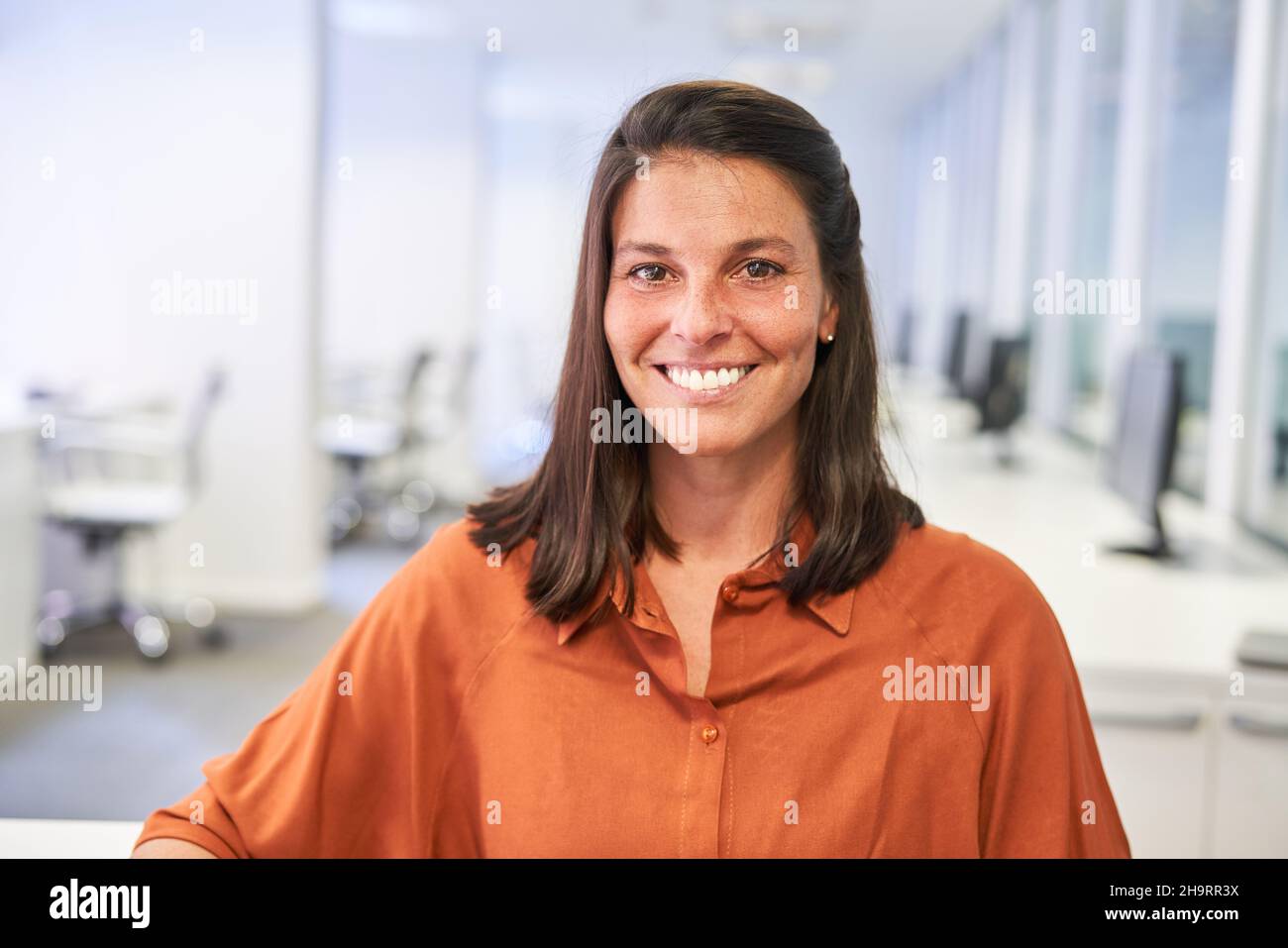 Happy business woman as a boss or managing director in an open plan ...