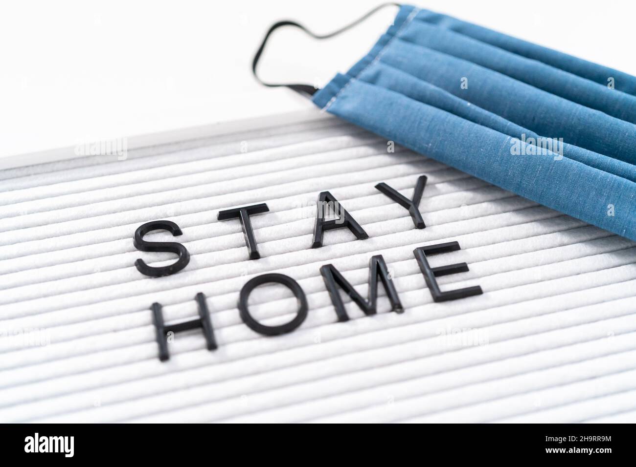 STAY HOME sign on message board with a homemade face mask Stock Photo ...