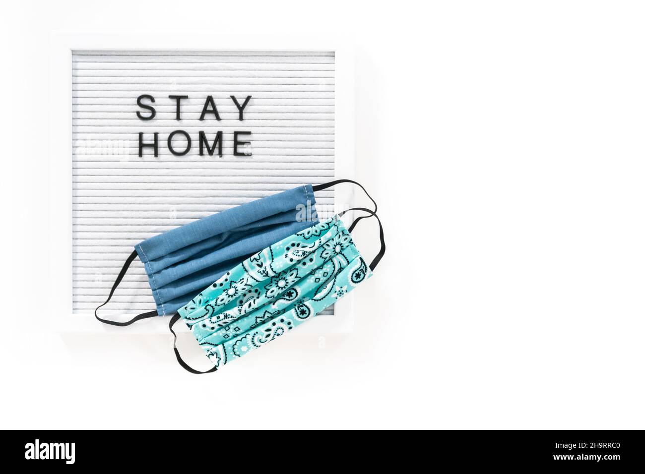 STAY HOME sign on message board with a homemade face mask Stock Photo ...