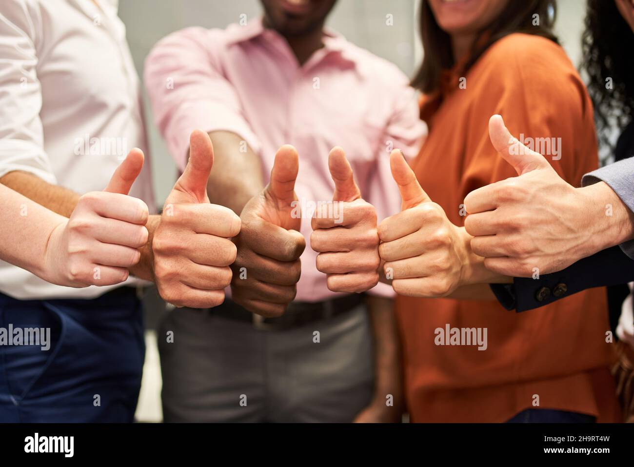 Group of business people showing the thumbs up together as a successful ...