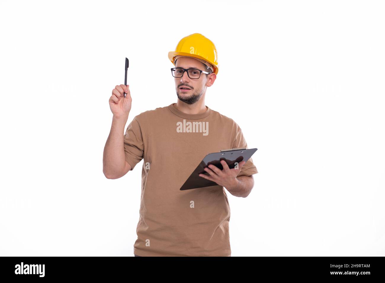 Builder Holding Clipboard in Hands Pointing with Pen Up. Construction ...