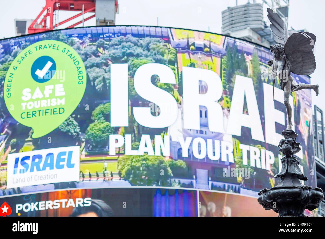 Pedestrians walk past an advertisement for Israeli tourism displayed on ...