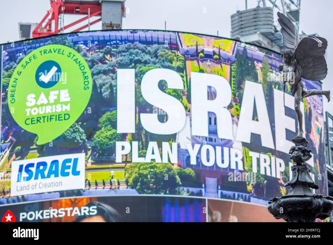 Pedestrians walk past an advertisement for Israeli tourism displayed on ...