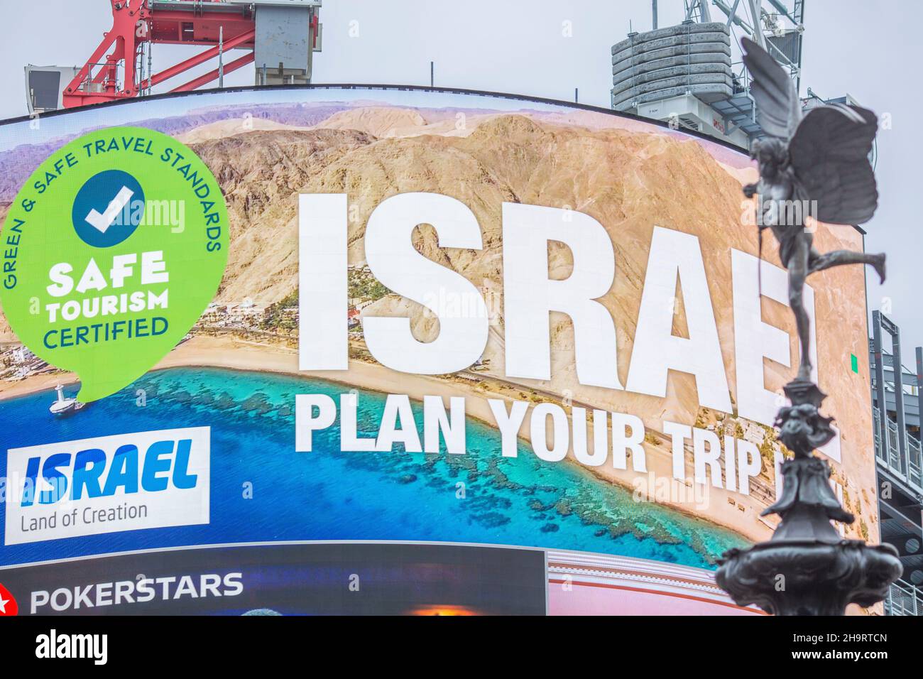 Pedestrians walk past an advertisement for Israeli tourism displayed on ...
