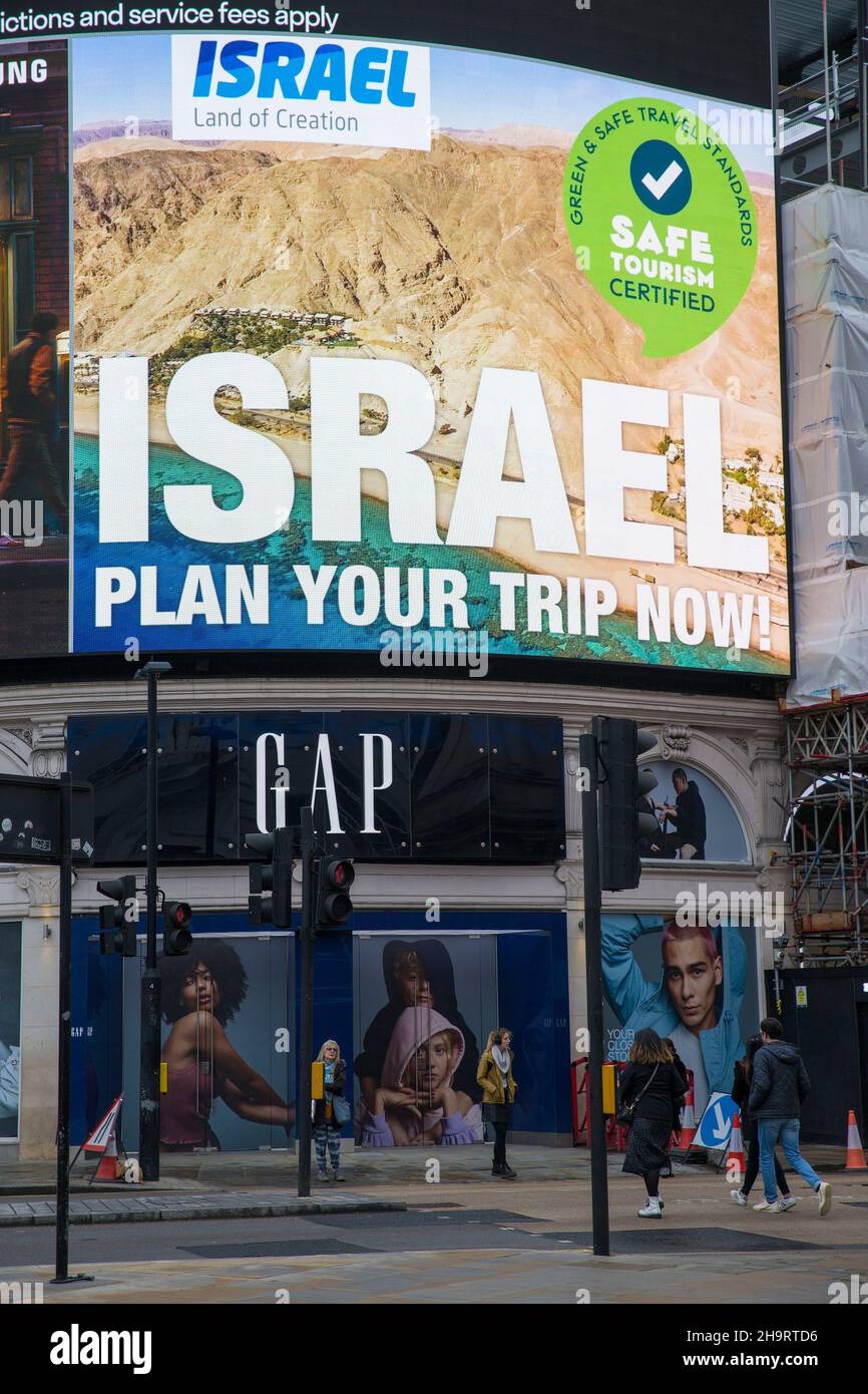 Pedestrians walk past an advertisement for Israeli tourism displayed on ...
