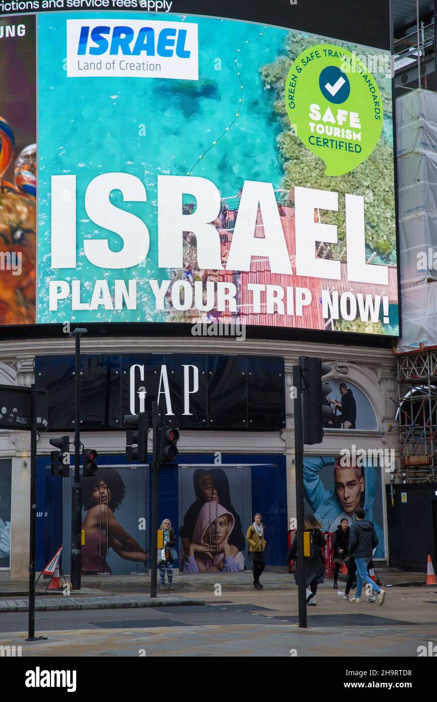 Pedestrians walk past an advertisement for Israeli tourism displayed on ...