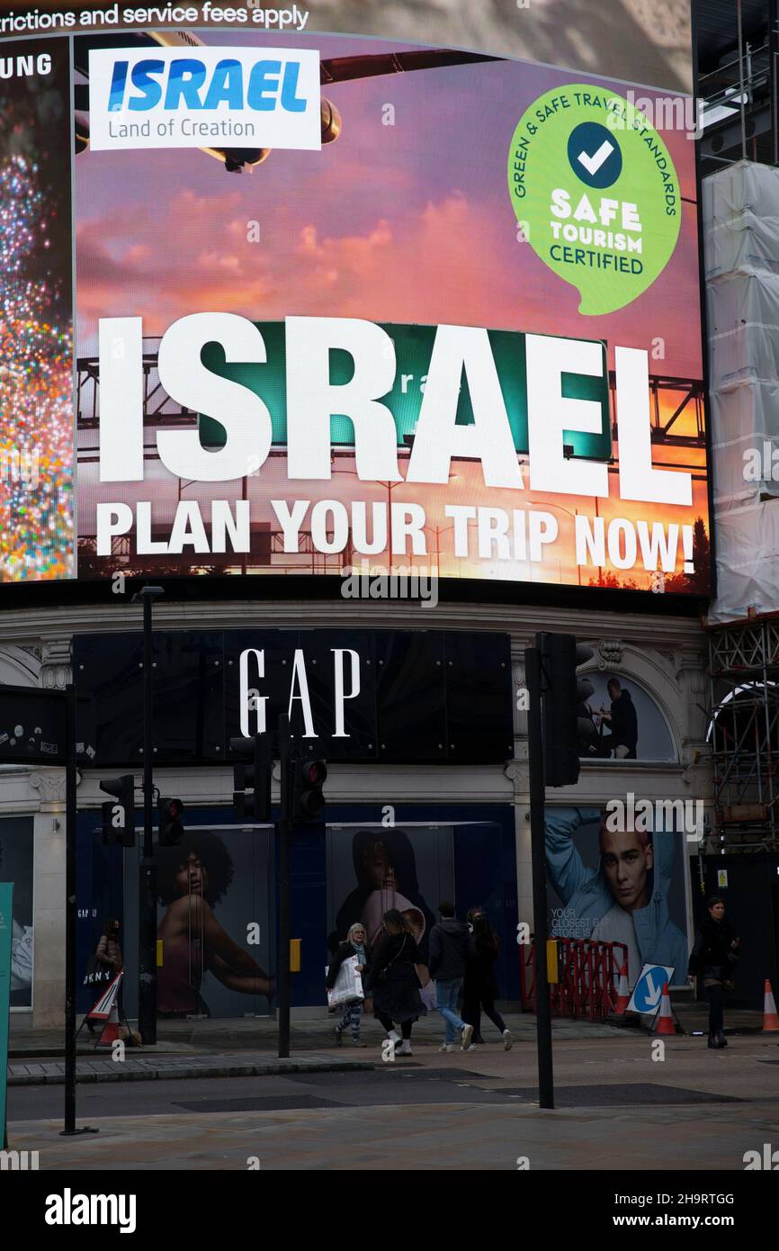 Pedestrians walk past an advertisement for Israeli tourism displayed on ...