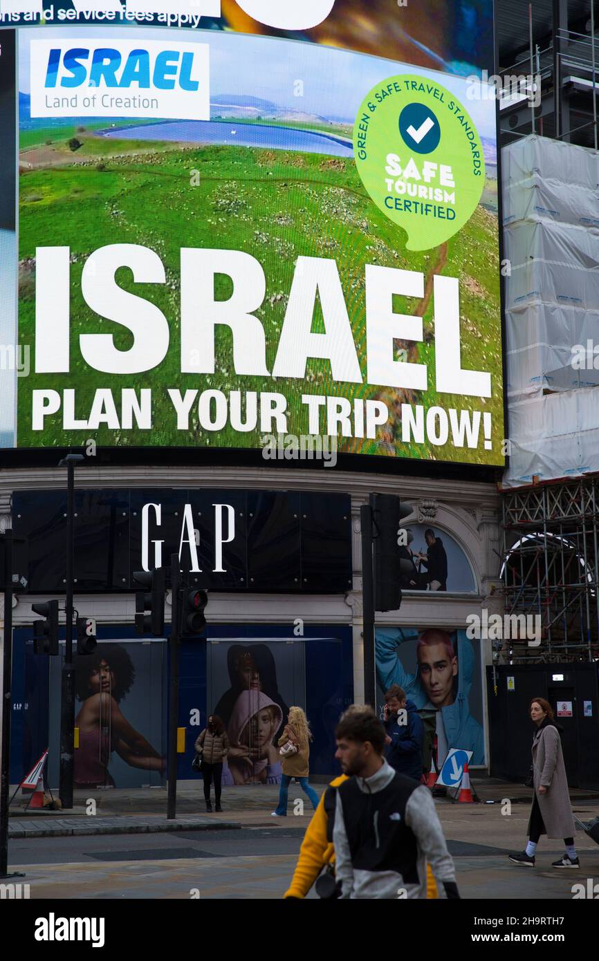 Pedestrians walk past an advertisement for Israeli tourism displayed on ...