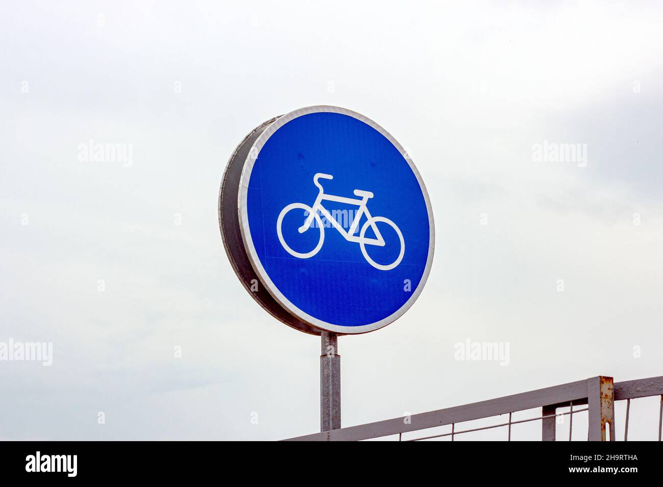 Blue and white bicycle lane sign indicating bike route, large round ...