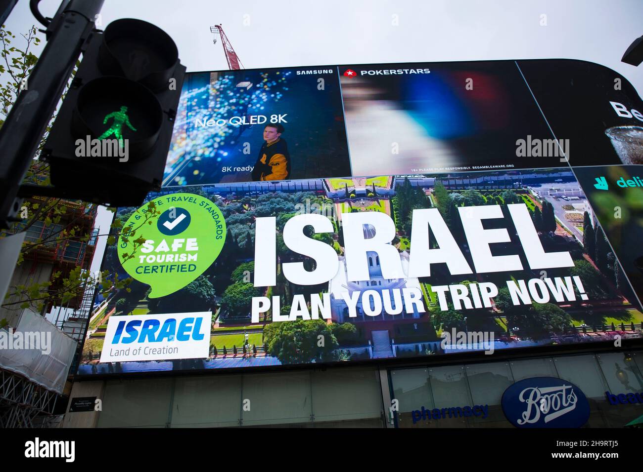 Pedestrians walk past an advertisement for Israeli tourism displayed on ...