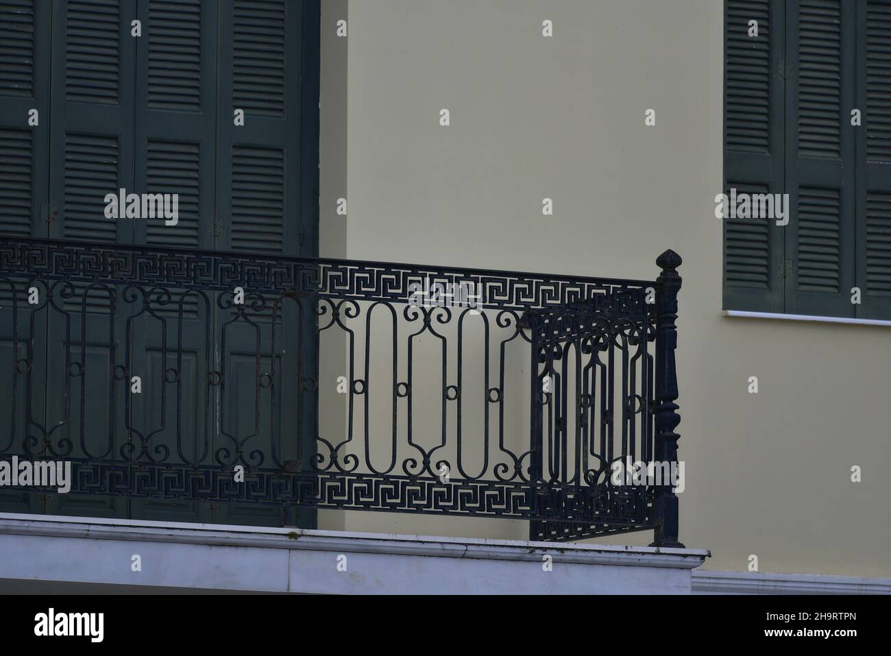 Old Neoclassical house facade with pine green wooden window shutters ...