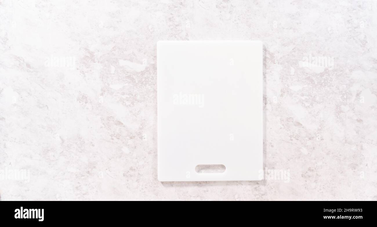 Flat lay. Empty white cutting board on the kitchen counter Stock Photo ...