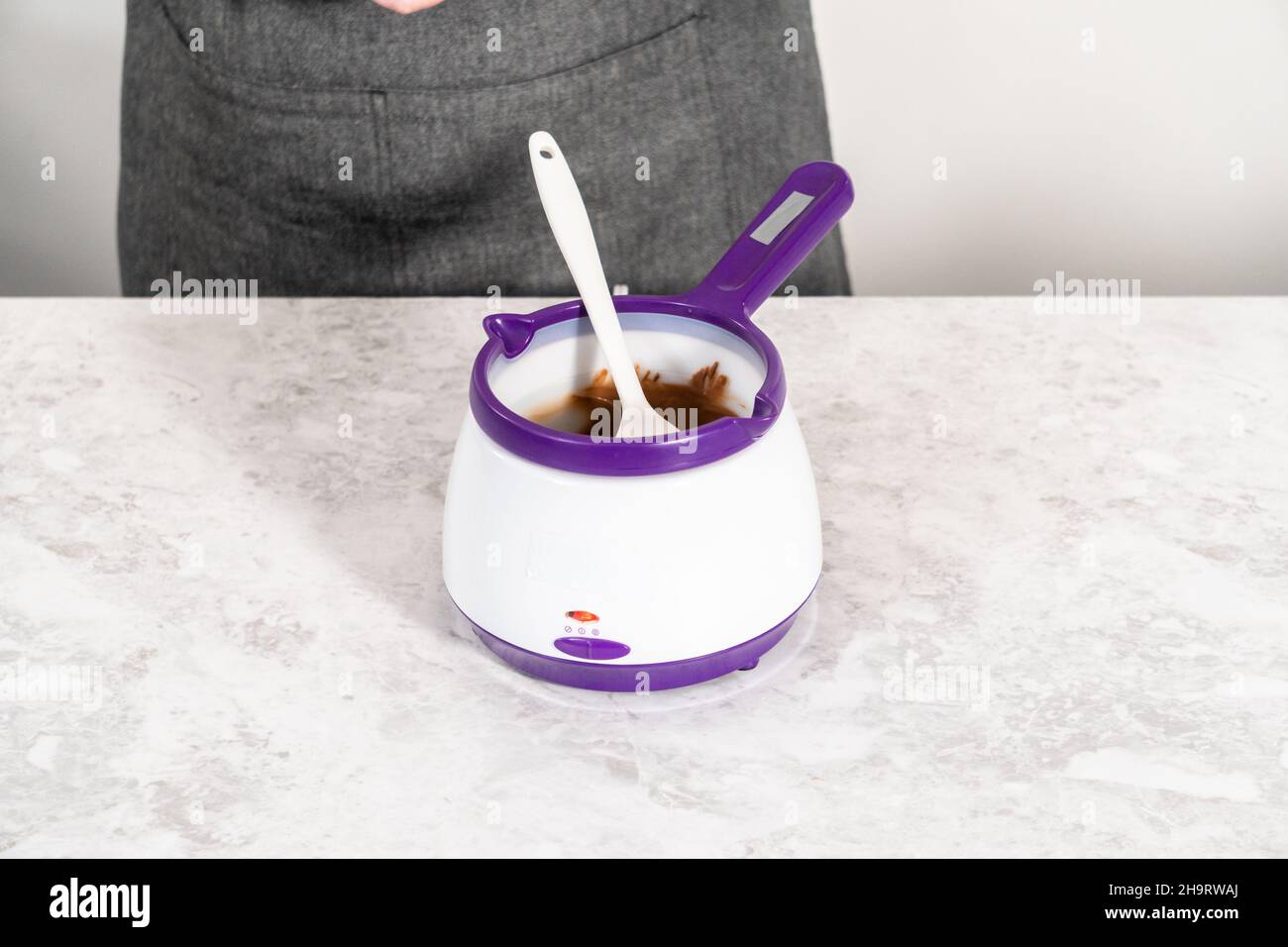 Melting chocolate melts in a candy melting pot to prepare gourmet mini ...