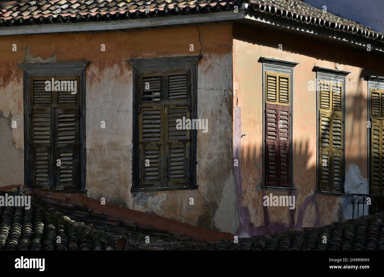 Exterior view of an old traditional Neoclassical house with a faded ...