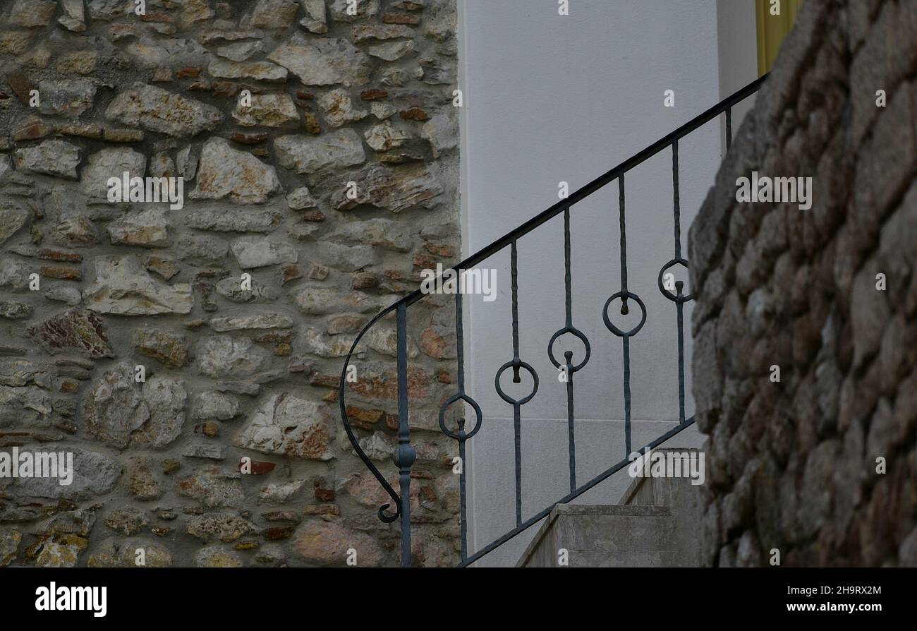 Old traditional rural house facade with a wrought iron hand railing ...