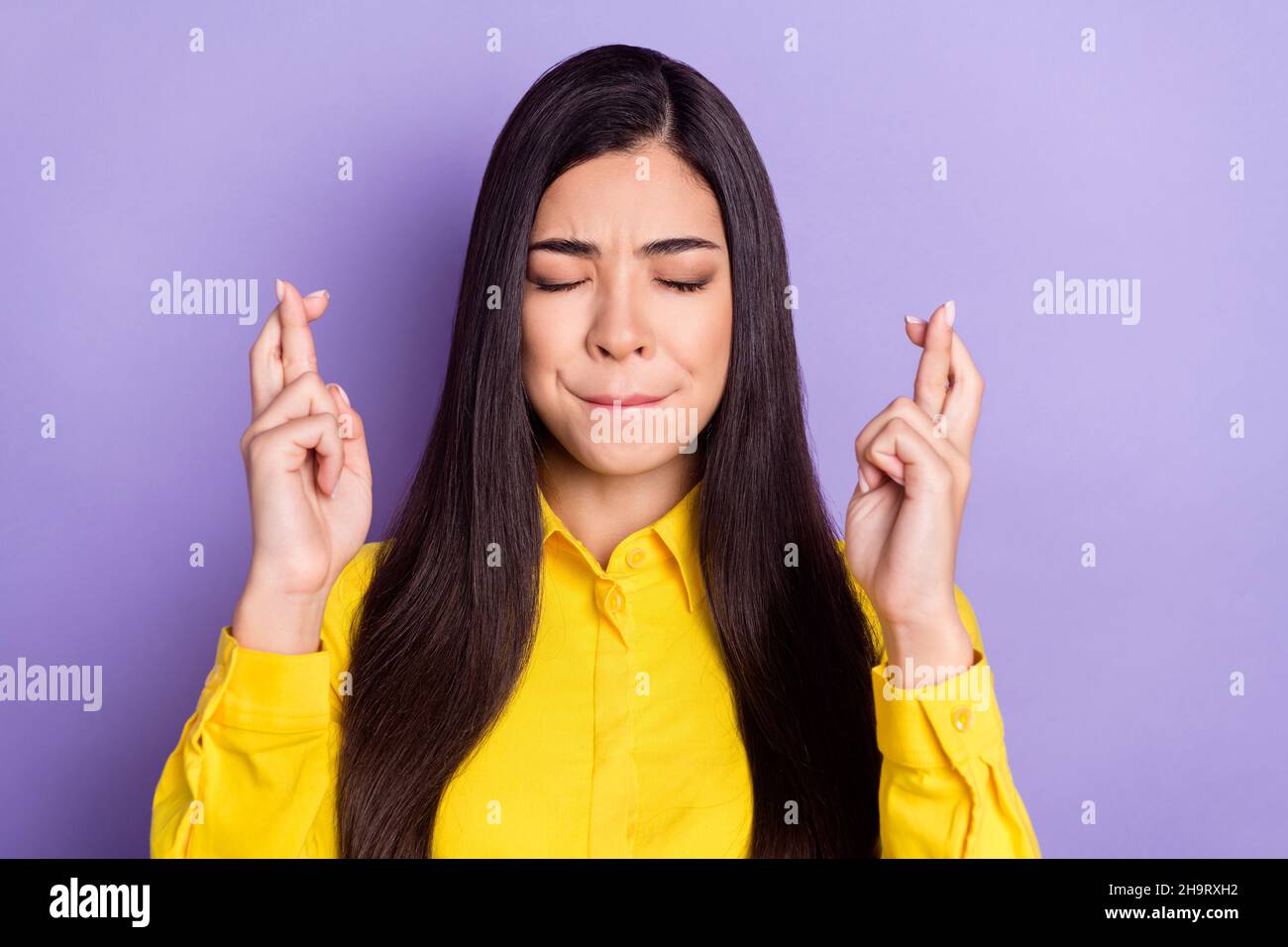 Photo of brown hairdo sad young lady crossed fingers closed eyes wear ...