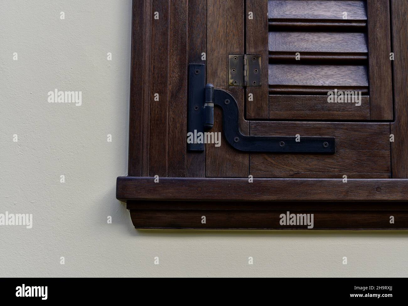 Natural cedar wooden window shutters with wrought iron hinges in ...