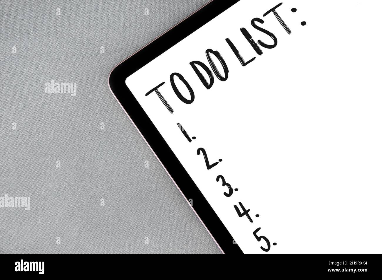 Digital tablet with to do list on gray fabric, textile background with ...