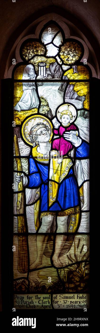 Stained glass window of Saint Peter carrying child Jesus Christ safely ...
