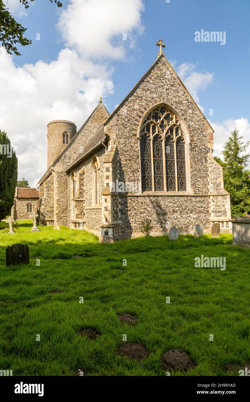 Gravestones in churchyard round tower of church of St John the Baptist ...