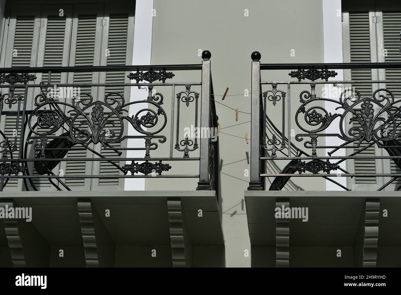 Neoclassical house facade with matching olive green wooden shutters and ...