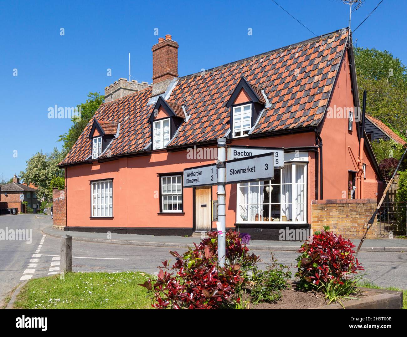 Road sign at village road junction distances to nearby places, Haughley ...