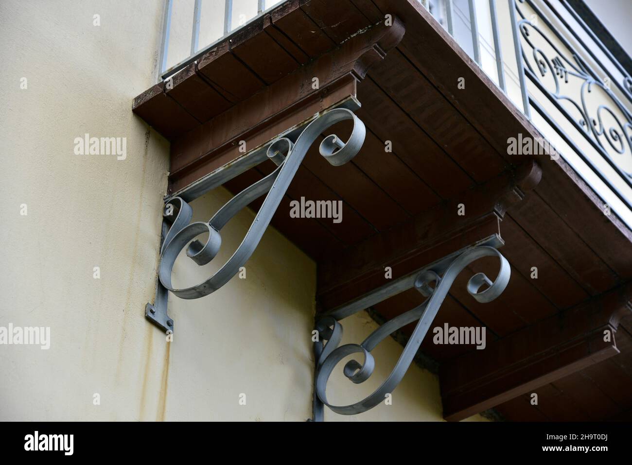 Old Neoclassical house balcony with handcrafted wrought iron support ...