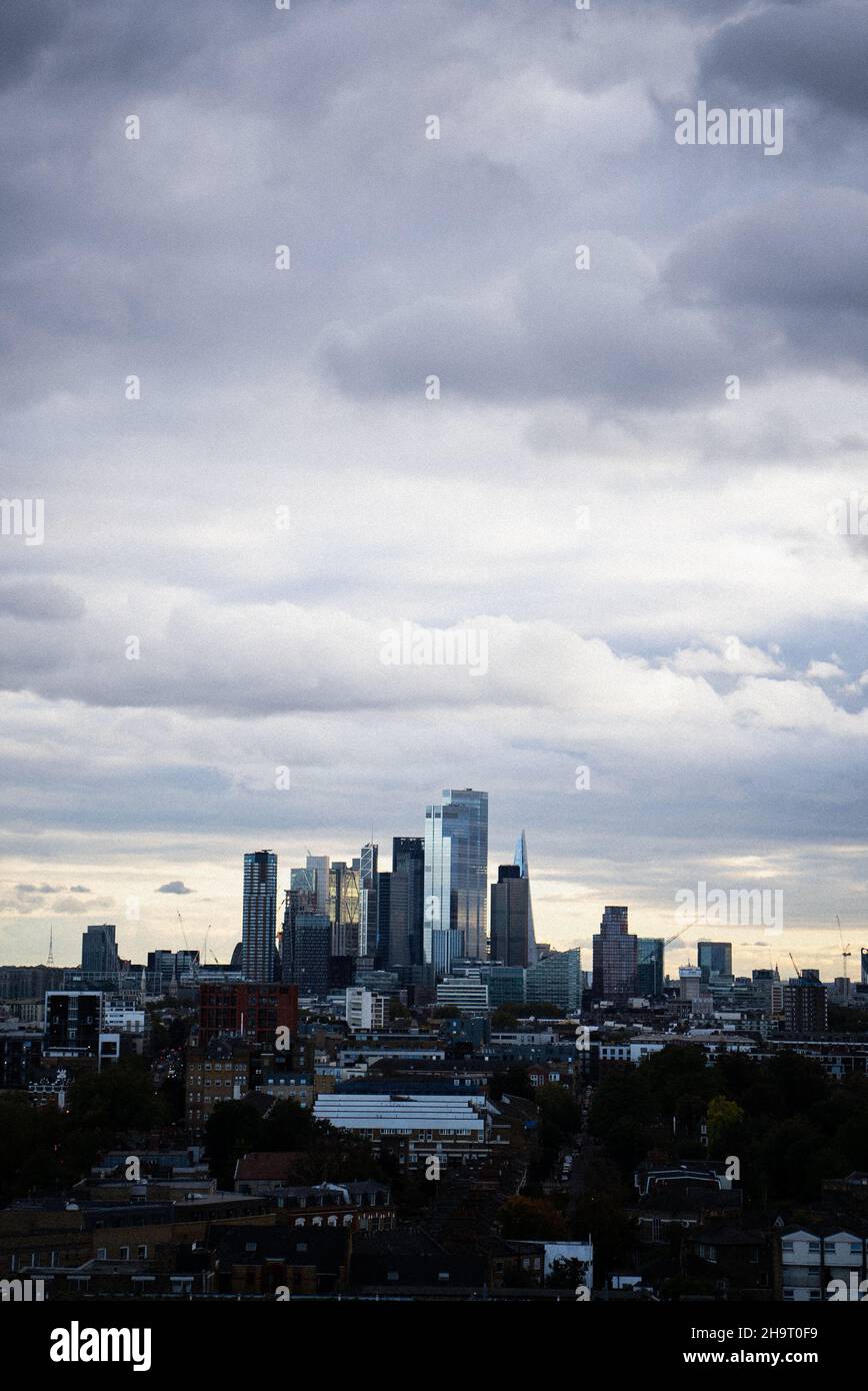 Vertical shot of buildings in a city on a sunset sky background Stock ...