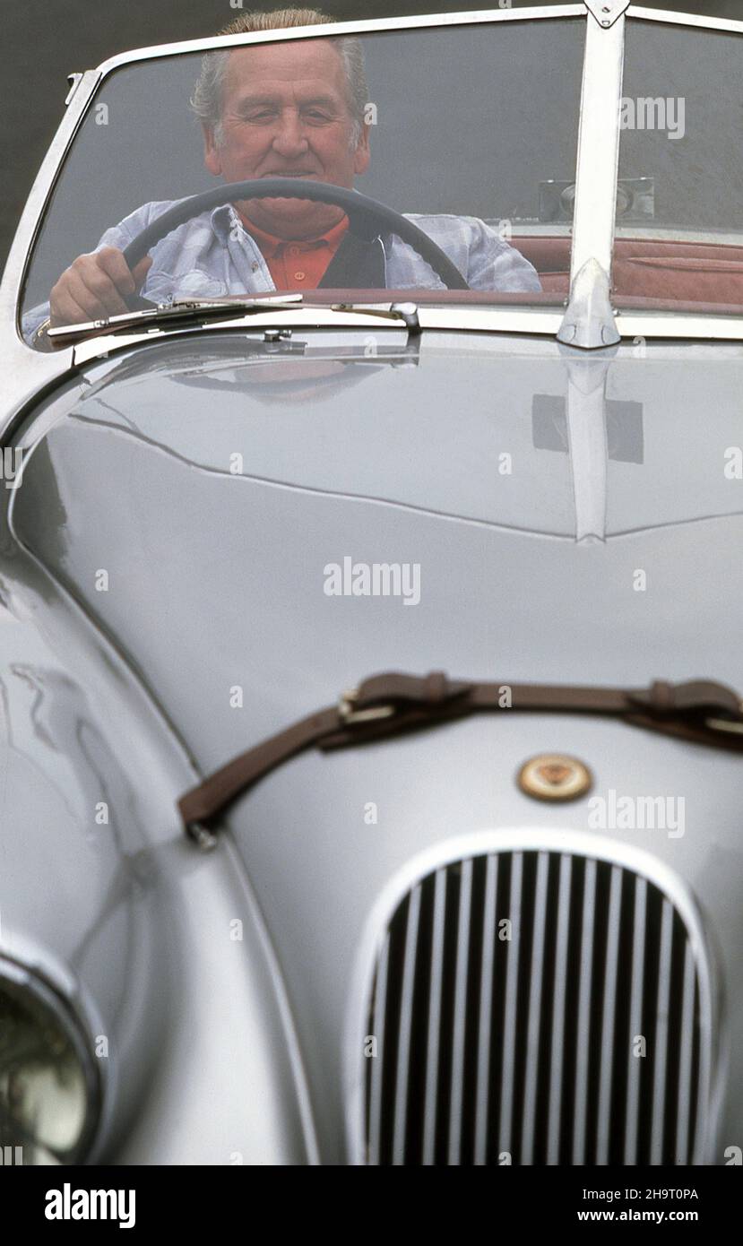 Jaguar Test driver Norman Dewis at the wheel of a 1954 Jaguar XK120 ...