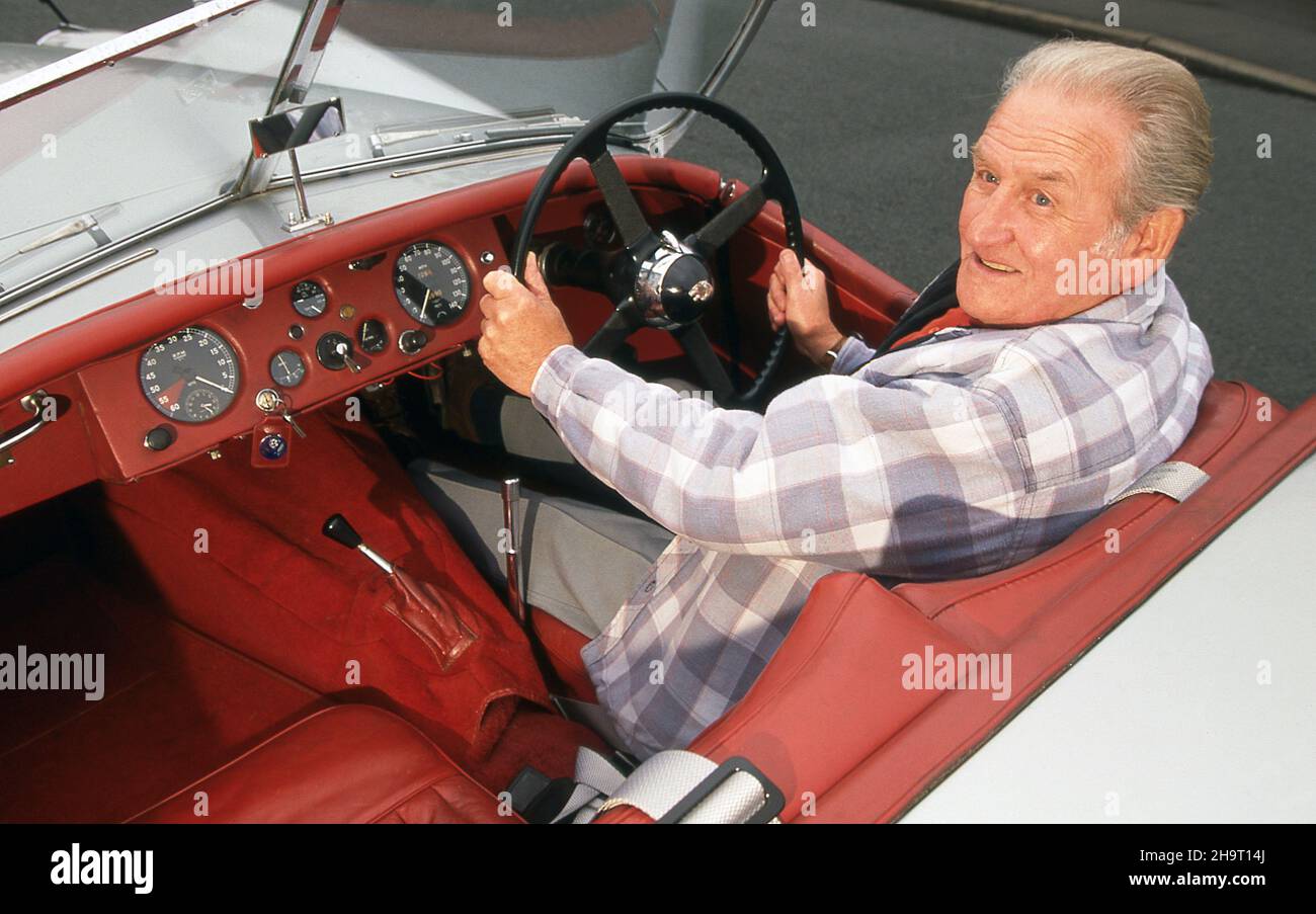 Jaguar Test driver Norman Dewis at the wheel of a 1954 Jaguar XK120 ...