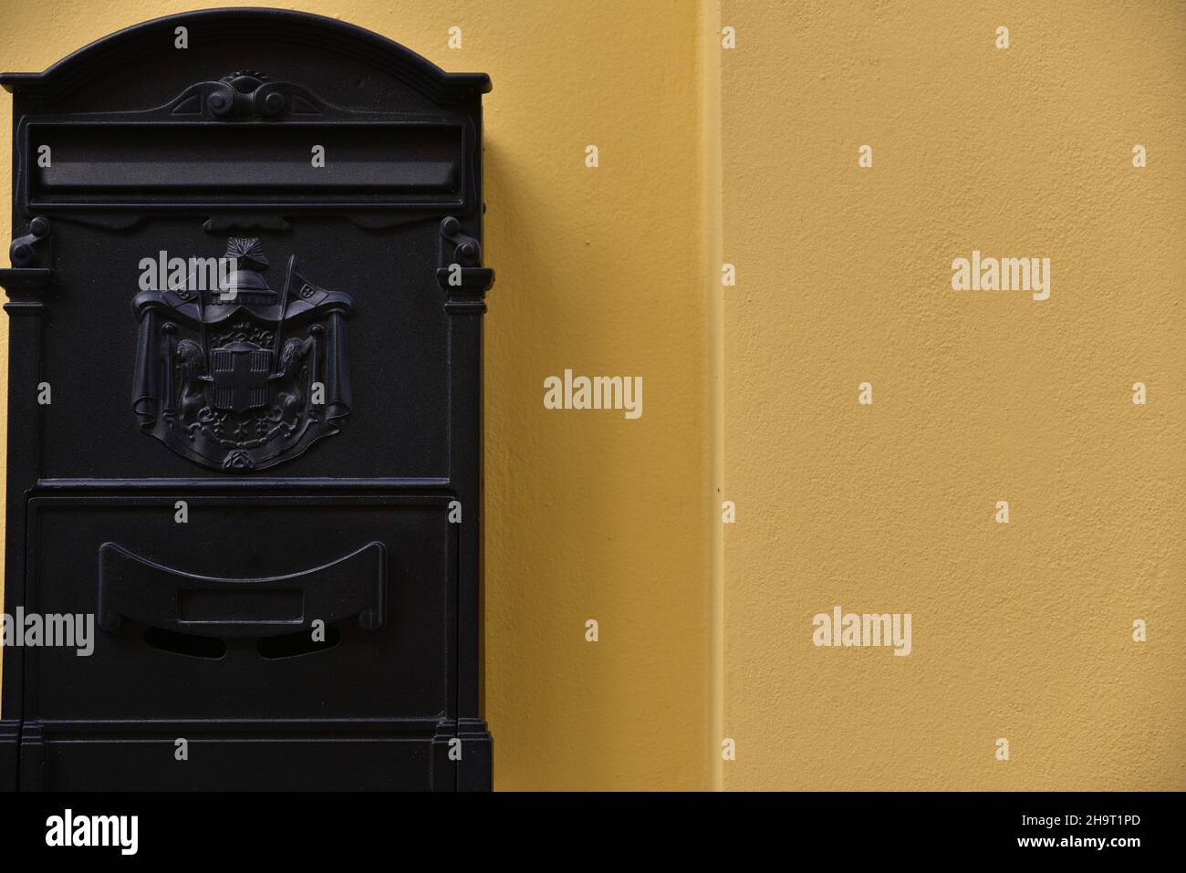 Antique cast iron mailbox against an ochre stucco wall in Nafplio ...