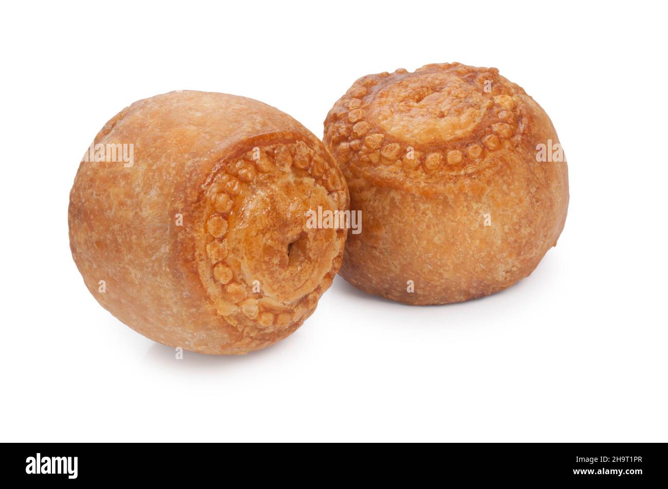 studio shot of small pork pies cut out against a white background ...