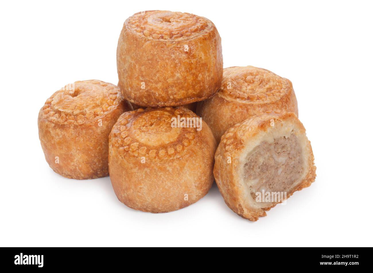 studio shot of small pork pies cut out against a white background ...