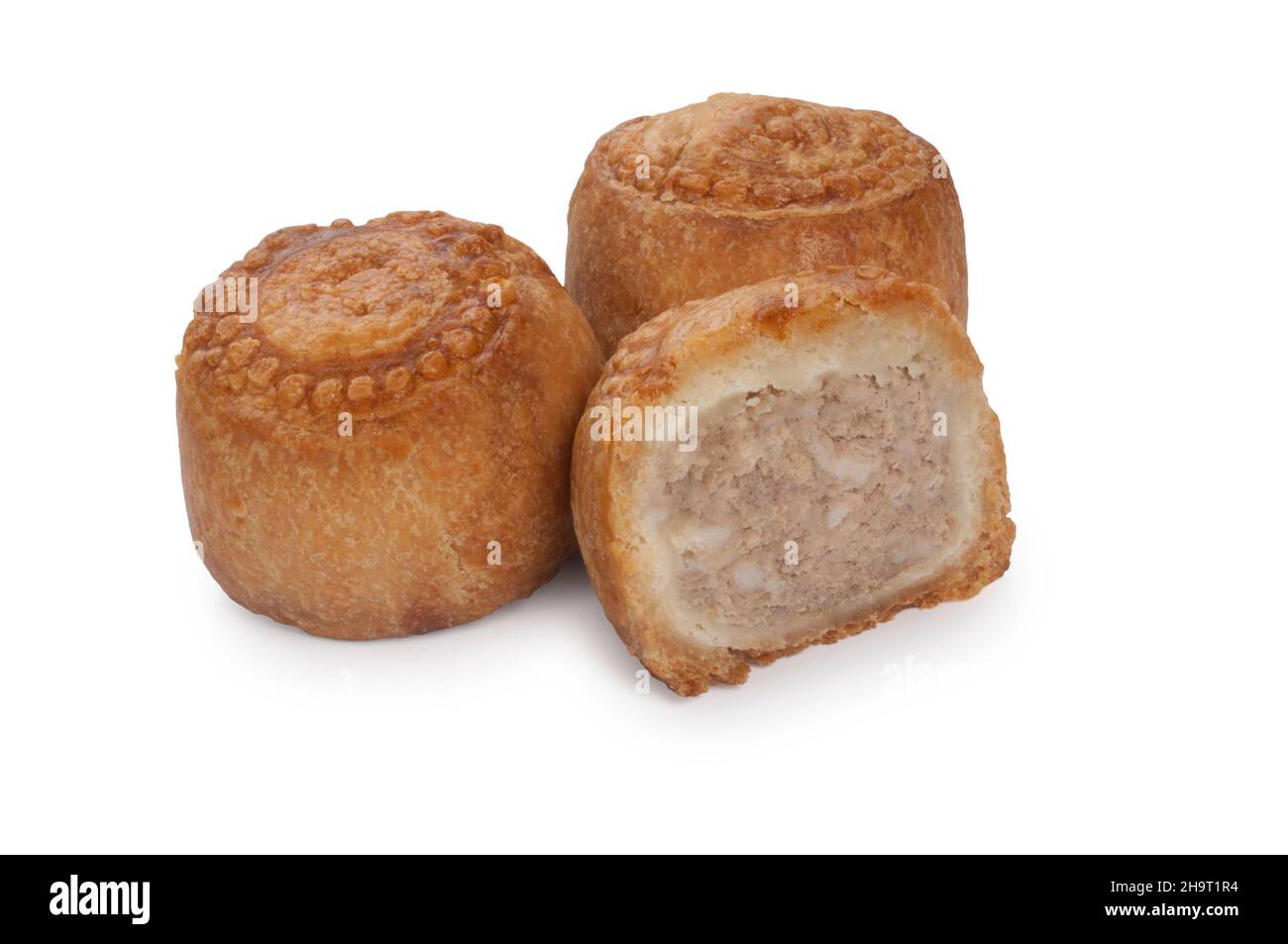 studio shot of small pork pies cut out against a white background ...